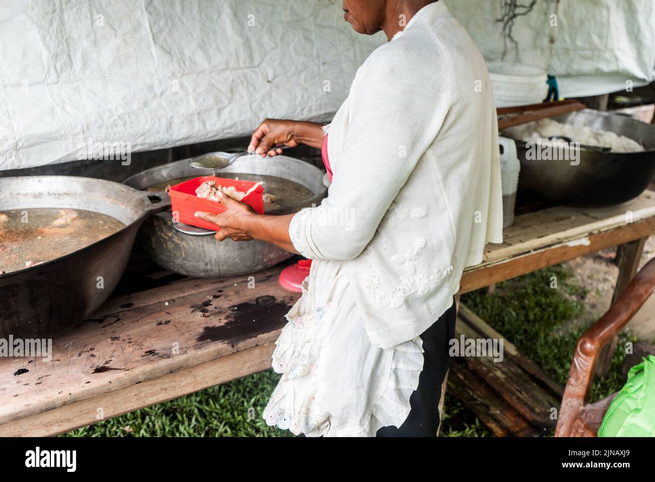 Indigenous woman cooking in her humble home on the Caribbean coast of ...