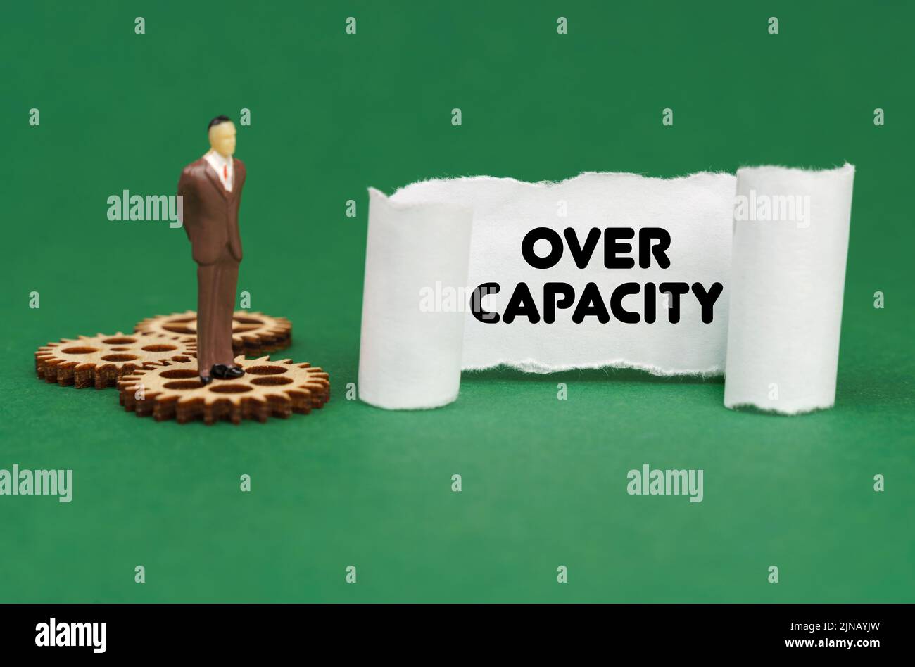 Business concept. The figure of a man stands on the gears and reads the ...