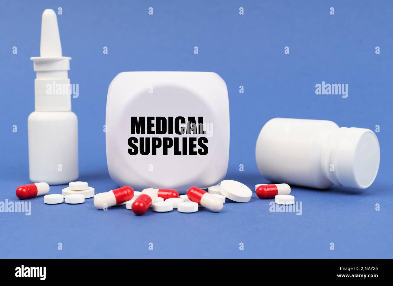 Medical concept. On the blue surface of the pill, capsule, spray, jar ...