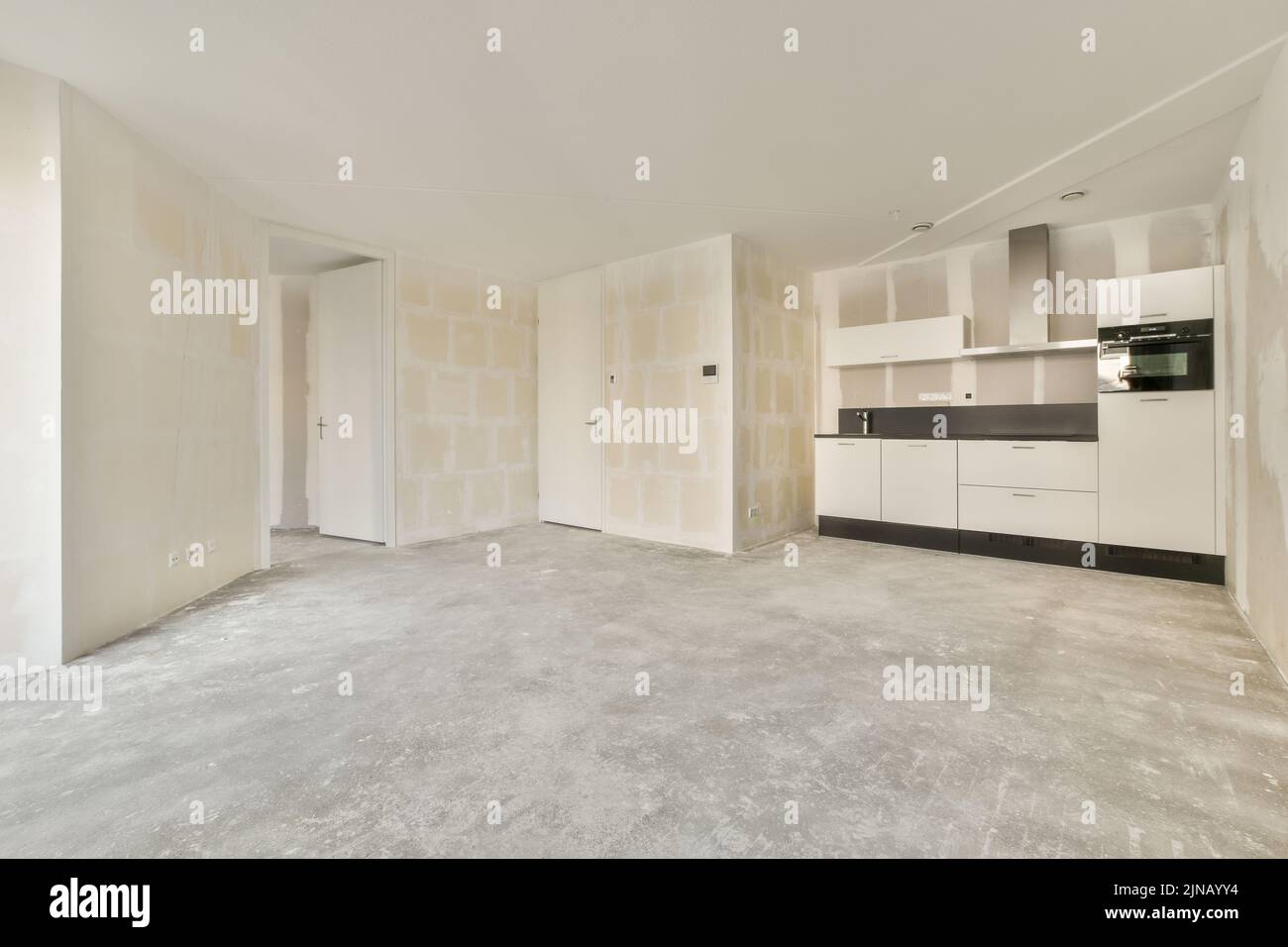 Interior of empty white kitchen with windows and wooden parquet floor ...