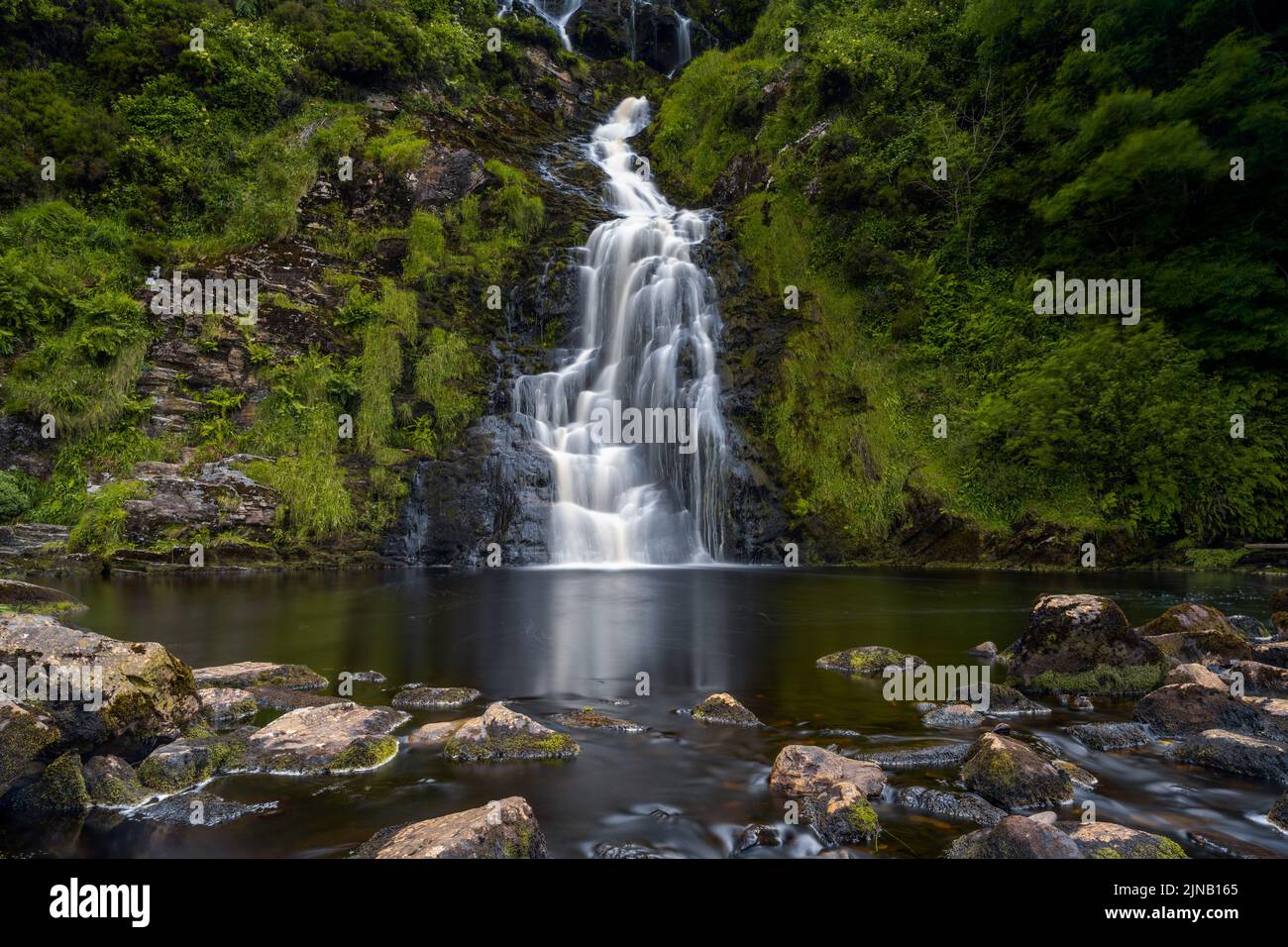 A horizontal view of the picturesque Assaranca Waterfall on the coast ...