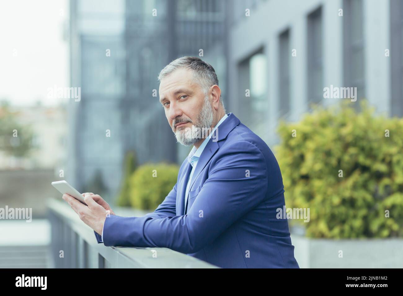 Portrait of serious and concentrated senior and experienced broker ...