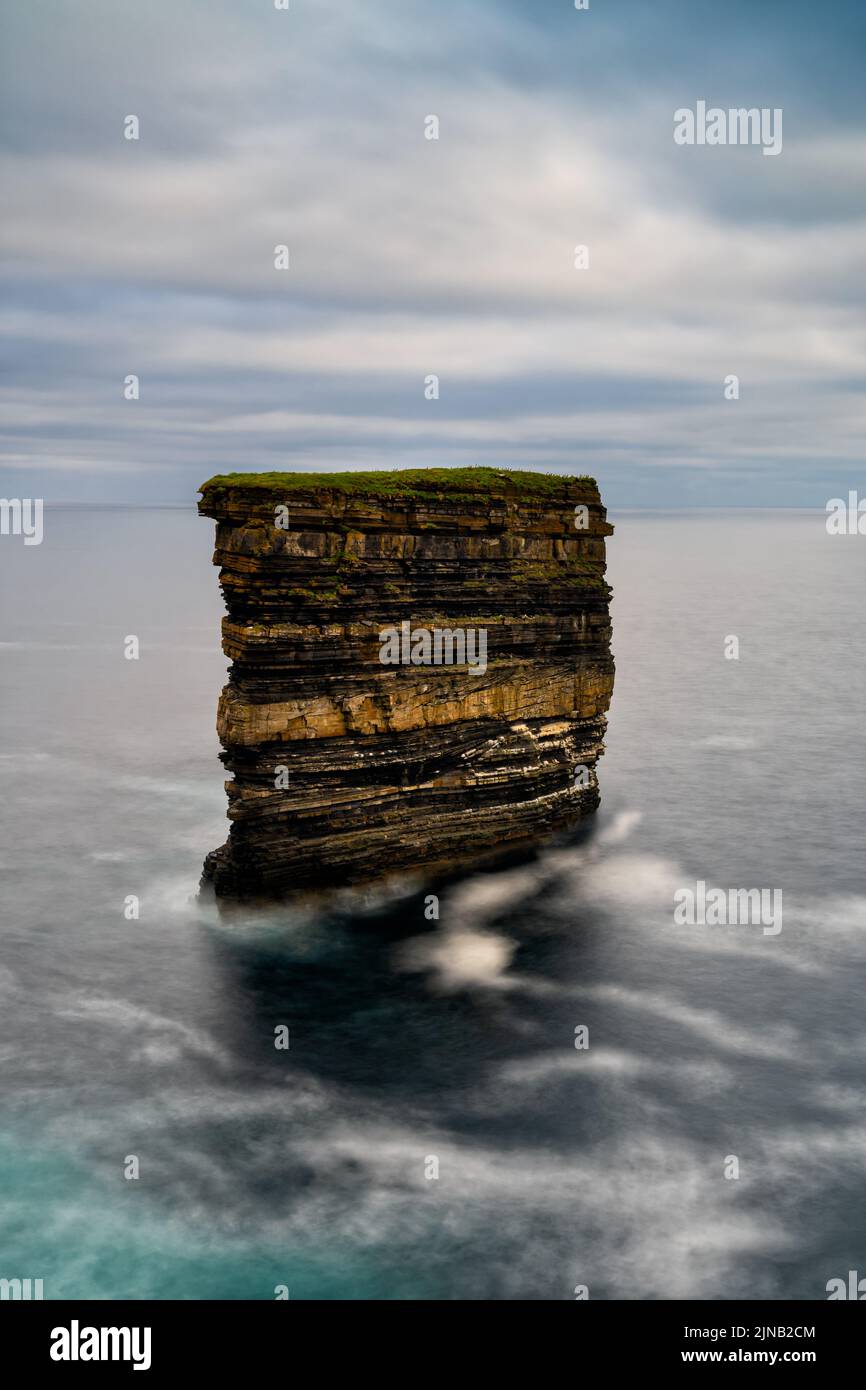 A long exposure view of the landmark sea stack Downpatrick Head in ...
