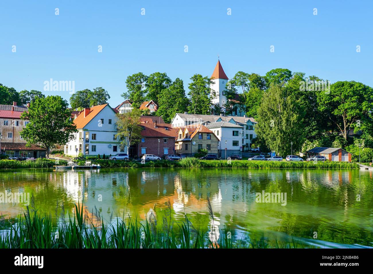 Beautiful old town houses and church panorama with lake reflection in ...