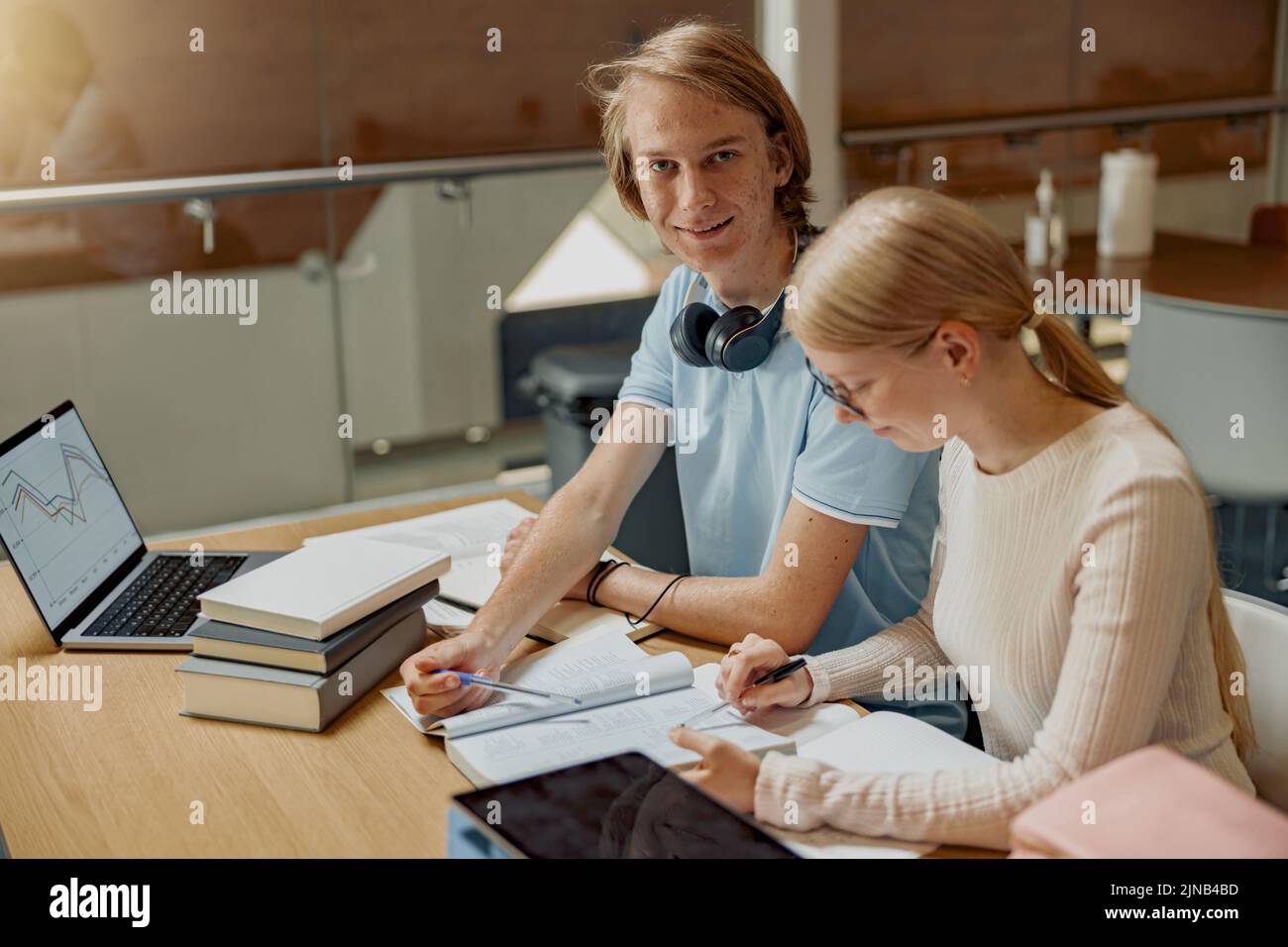 Two talented students working together on university project sitting in ...