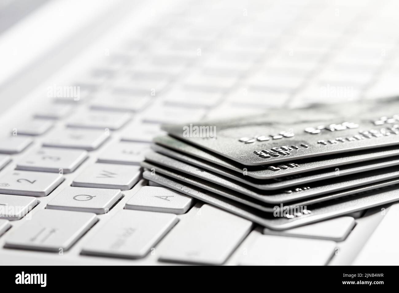 Several bank credit cards on a laptop keyboard Stock Photo - Alamy