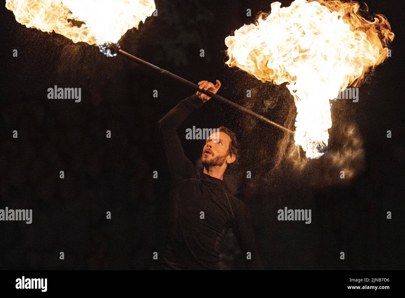 A fire juggler doing tricks with one hand in Hungary Stock Photo - Alamy