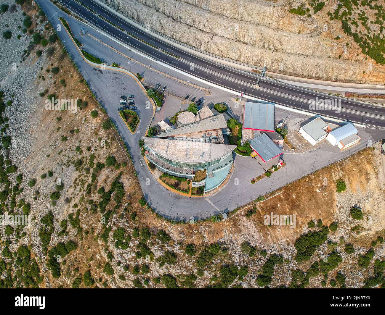 Aerial panoramic view over Moreas Motorway at Artemisio mount. A7 ...