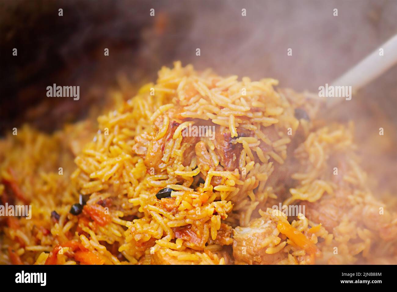 Pilaf cooked on a fire. Preparation of pilaf dish close-up Stock Photo ...