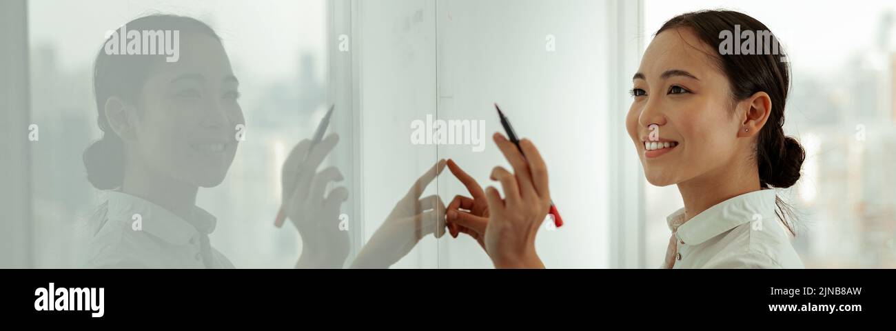 Smart asian business woman write project plan on flipboard during ...
