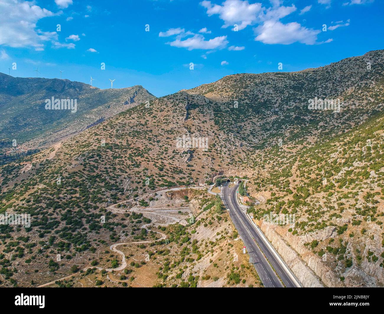 Aerial panoramic view over Moreas Motorway at Artemisio mount. A7 ...