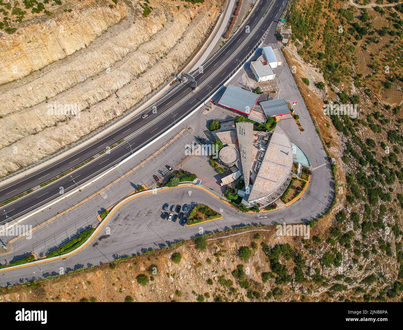 Aerial panoramic view over Moreas Motorway at Artemisio mount. A7 ...