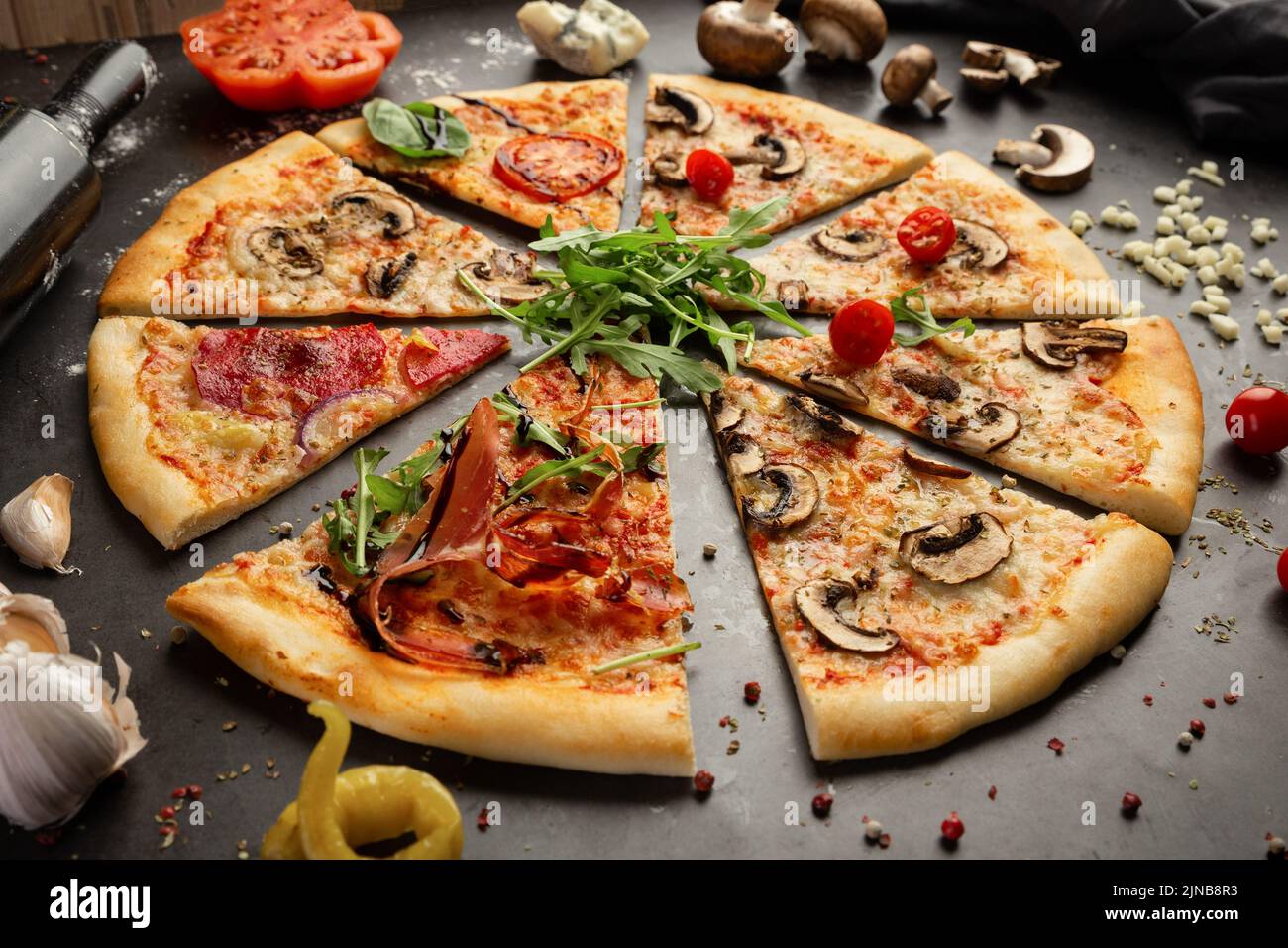 Different taste pizza on table background Stock Photo - Alamy
