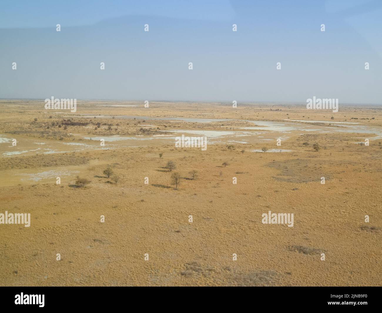 Aerial views of expansive flat landscape while flying over Botswana ...