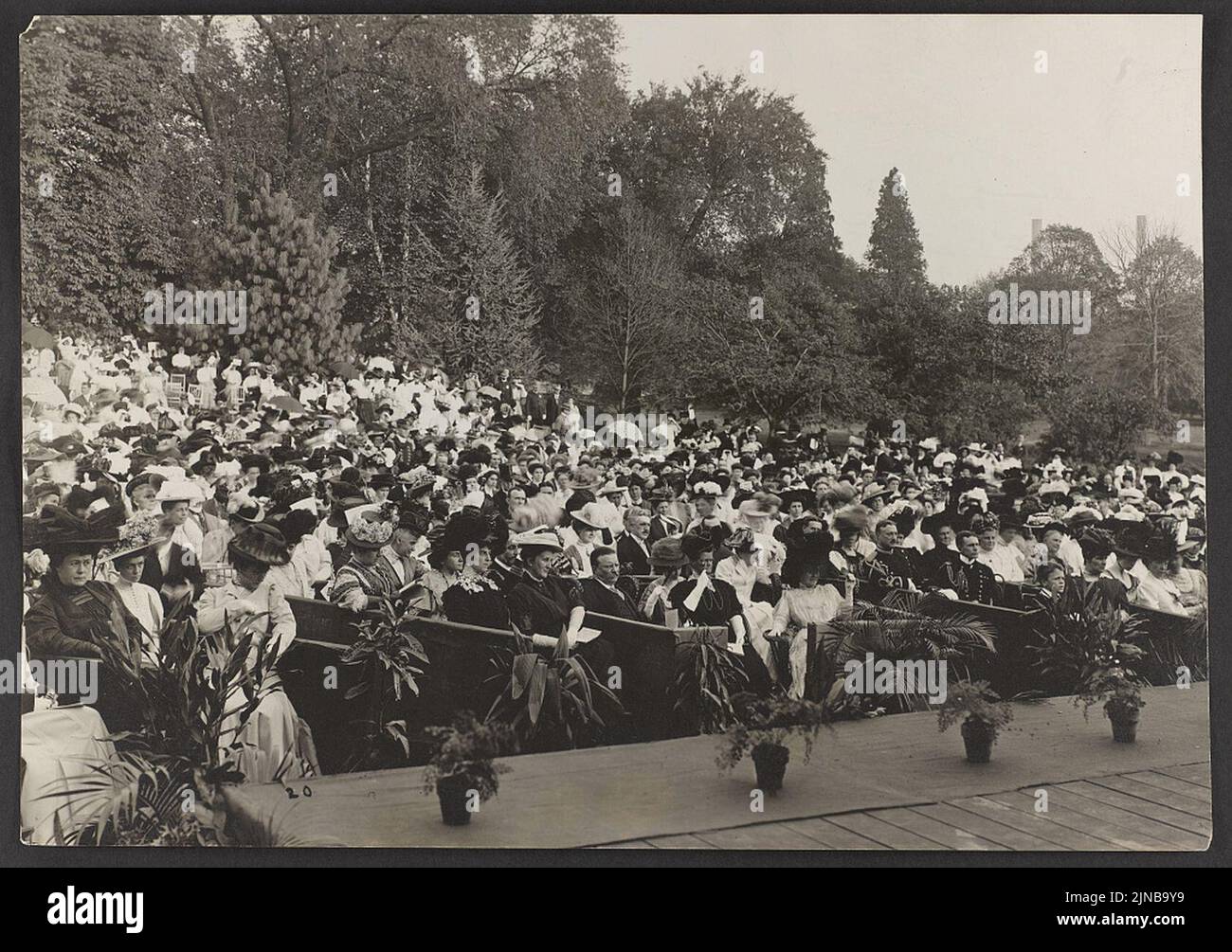 Teddy Roosevelt seated in an outdoor stage box, surrounded by other ...
