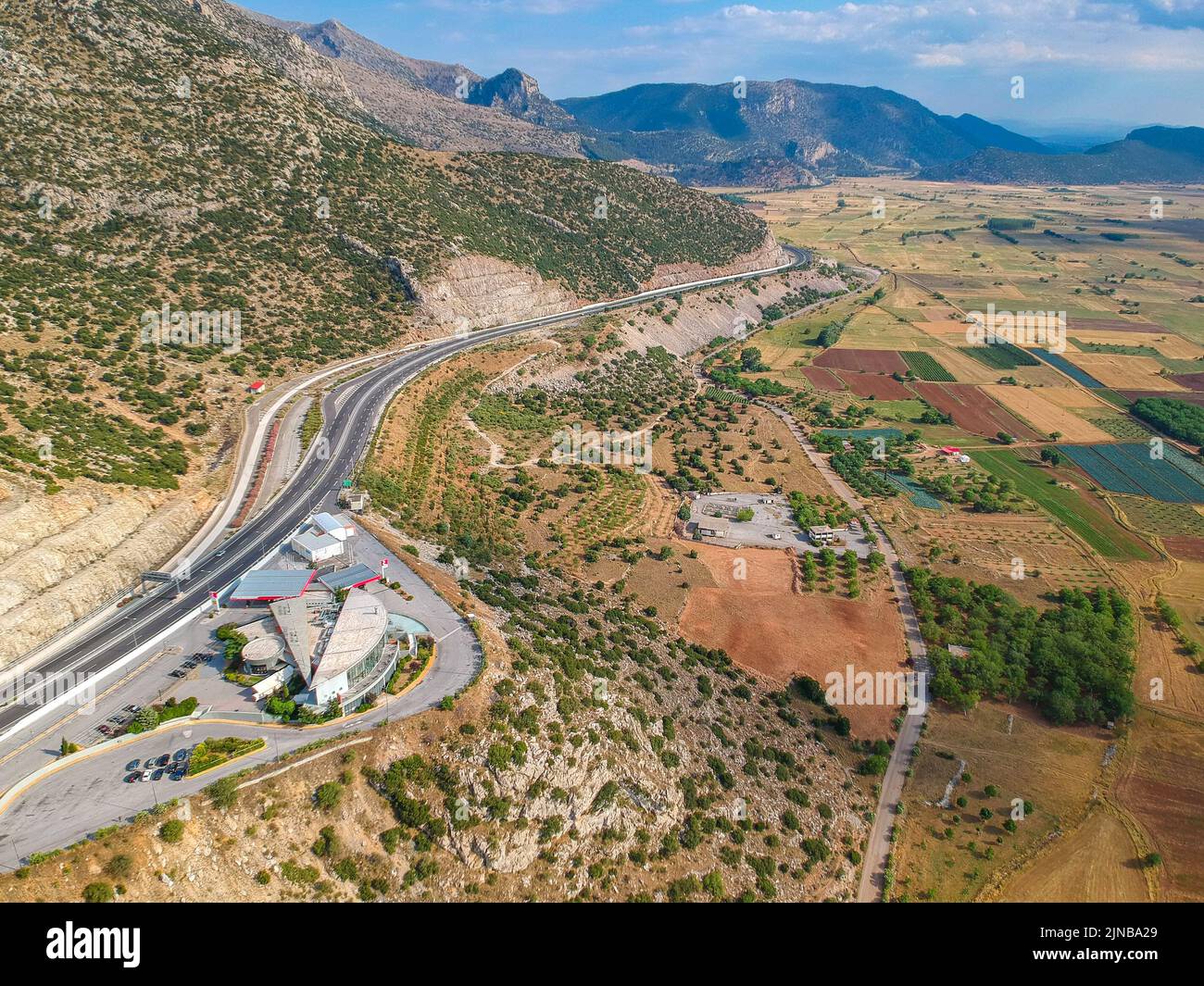 Aerial panoramic view over Moreas Motorway at Artemisio mount. A7 ...