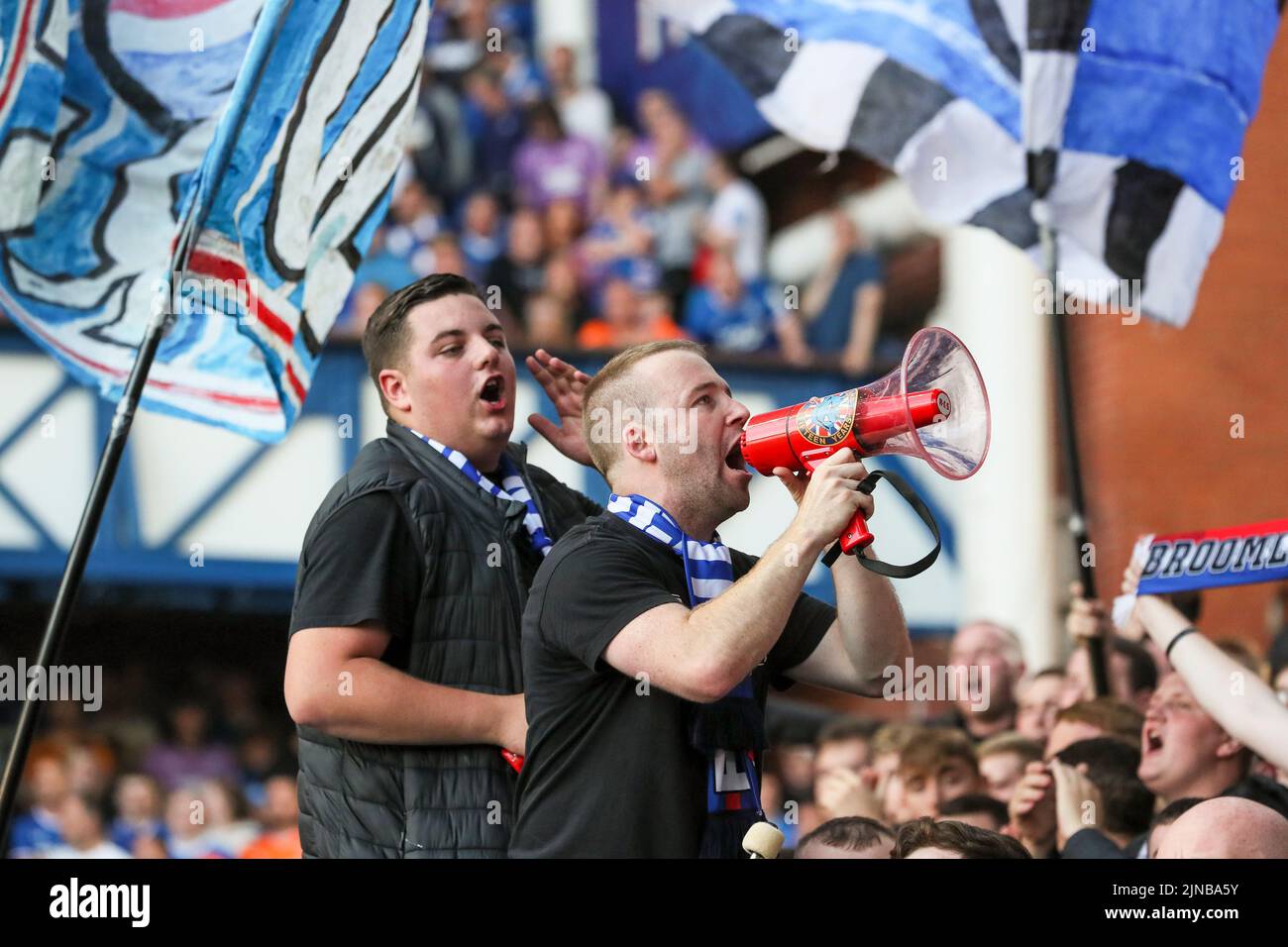 A supporter of Rangers FC football club co-ordinating the chanting and ...
