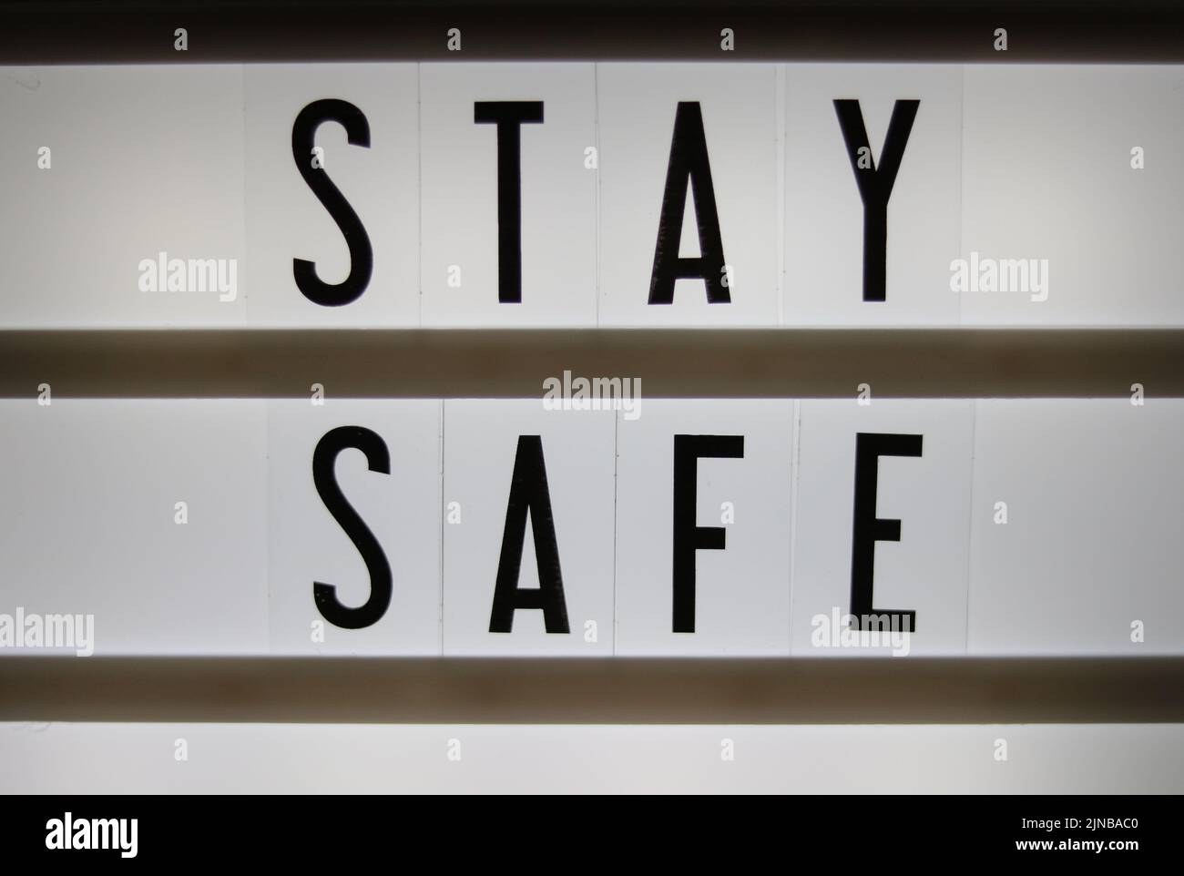 Lightbox sign saying Stay Safe written in black letters on white ...