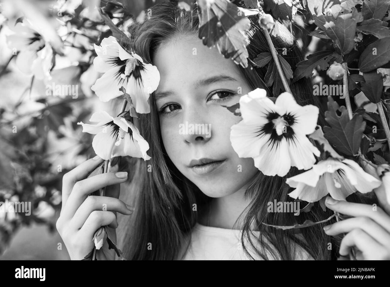 happy childhood. cheerful pretty child at blooming tree outdoor ...