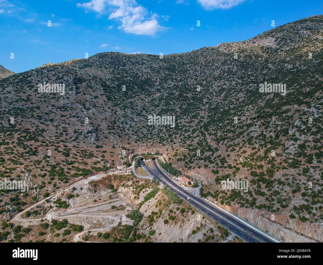 Aerial panoramic view over Moreas Motorway at Artemisio mount. A7 ...