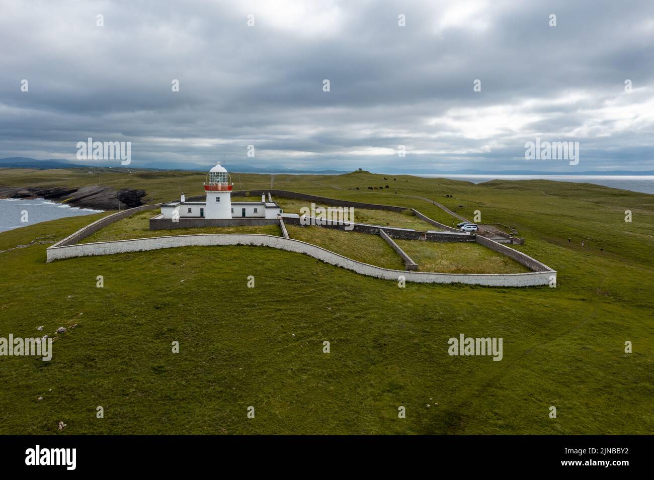 A view of the historic harbor lighthouse at St. John's Point in Donegal ...
