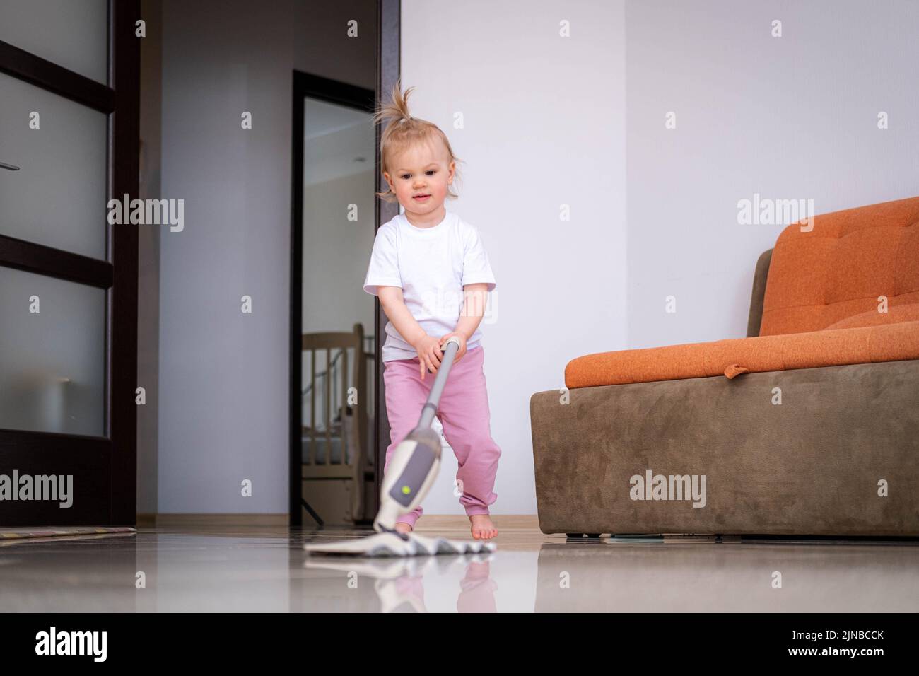 little daughter cleaning in the house, child dusting, Cute little ...