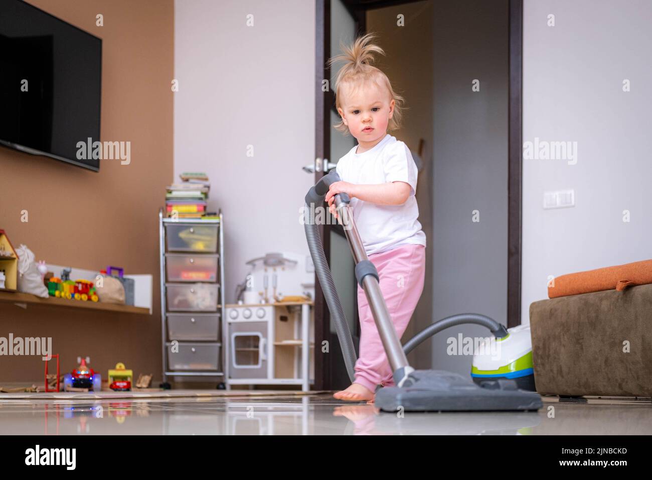 little daughter cleaning in the house, child dusting, Cute little ...