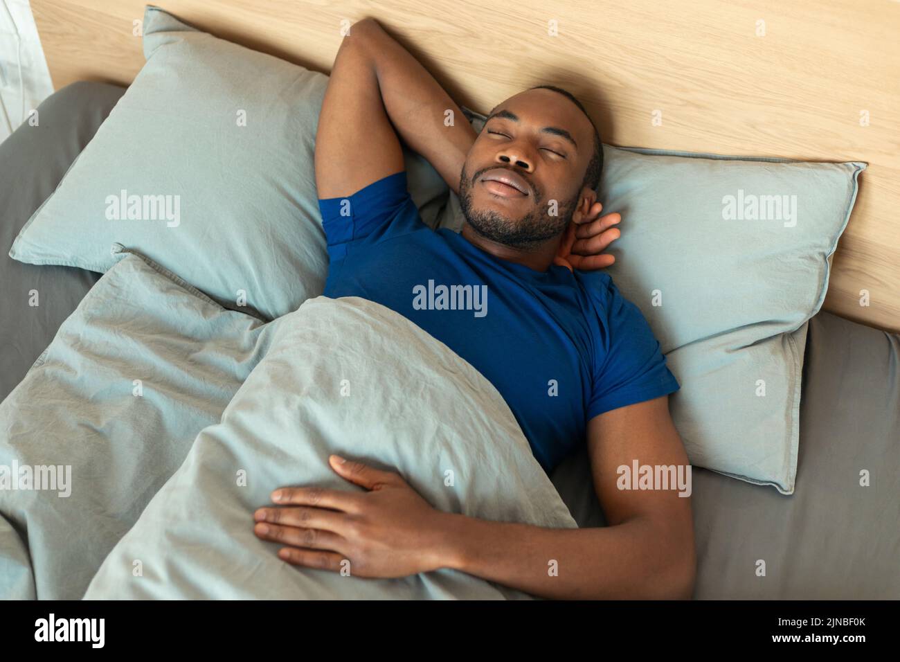 High Angle Shot Of Sleeping Black Man Napping In Bedroom Stock Photo ...