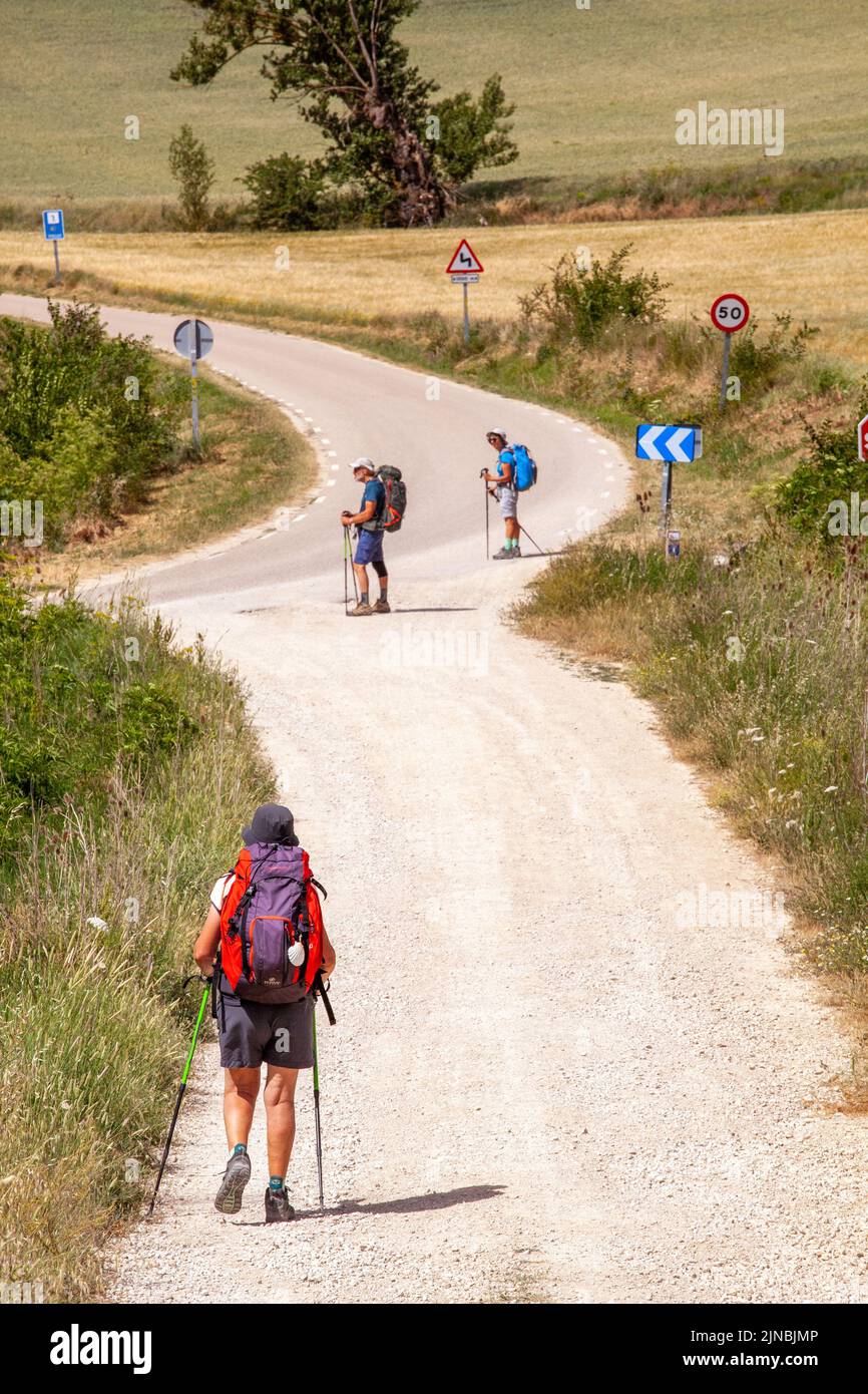 Pilgrims walking the Camino de Santiago pilgrimage route the way of St ...