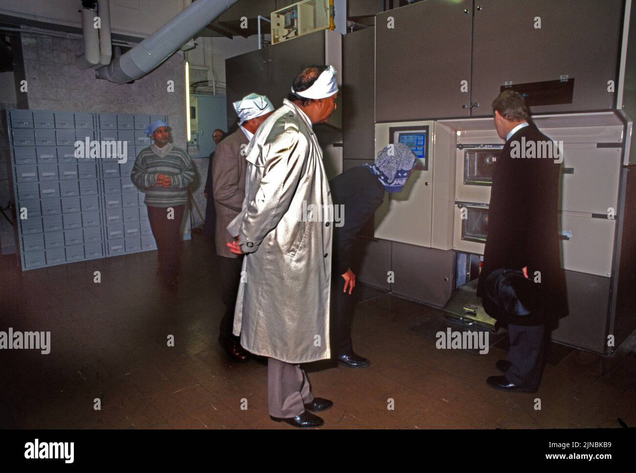 Sikh Men Watching Coffin In Furnace at a Crematorium Surrey England ...