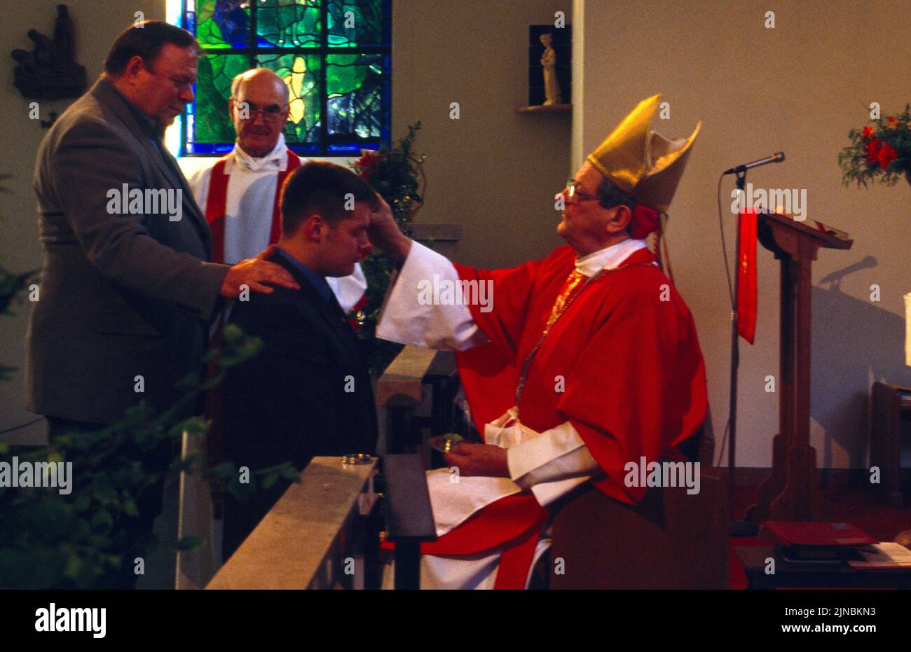 Confirmation At Pentecost Man Kneeling Before Bishop While he Annoints ...