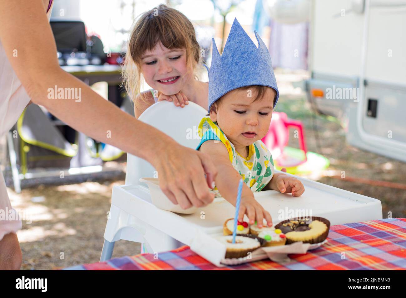 children and family celebrating baby boy's first birthday party in a ...