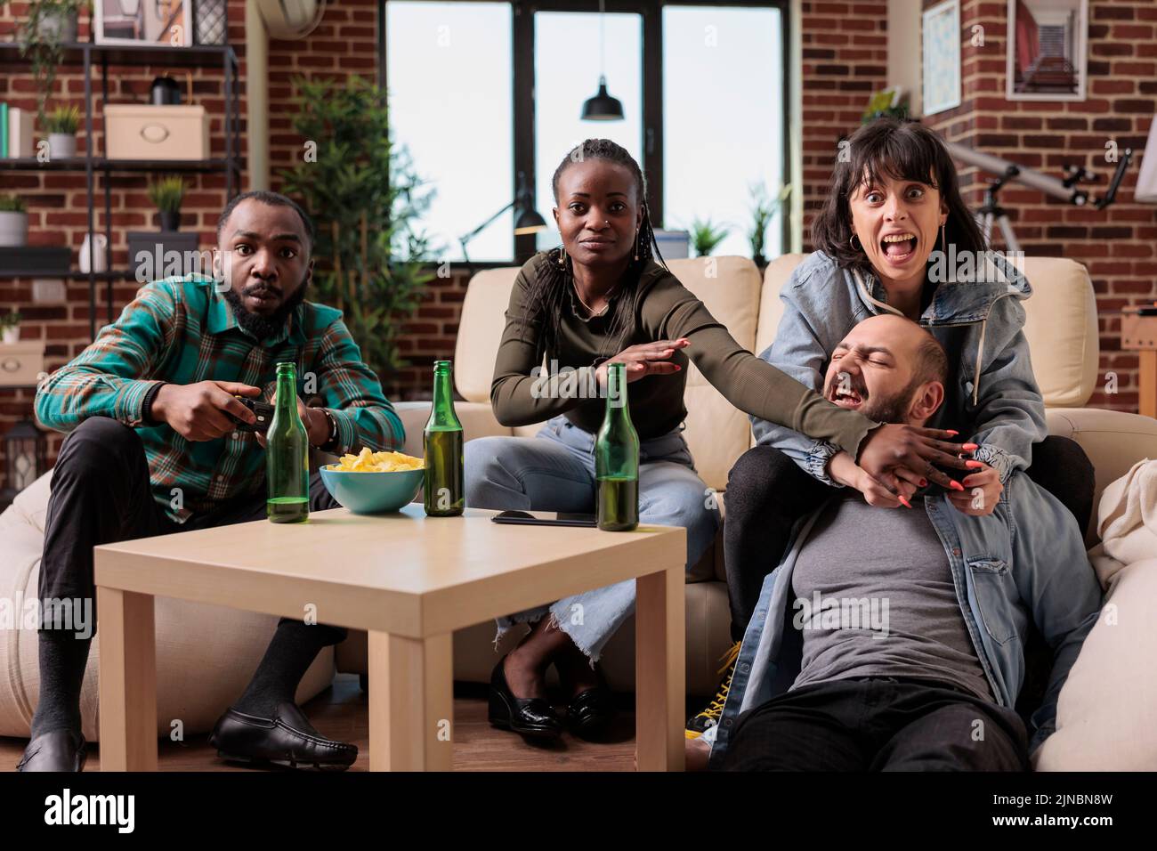 Happy group of friends having fun with video games strategy, playing ...