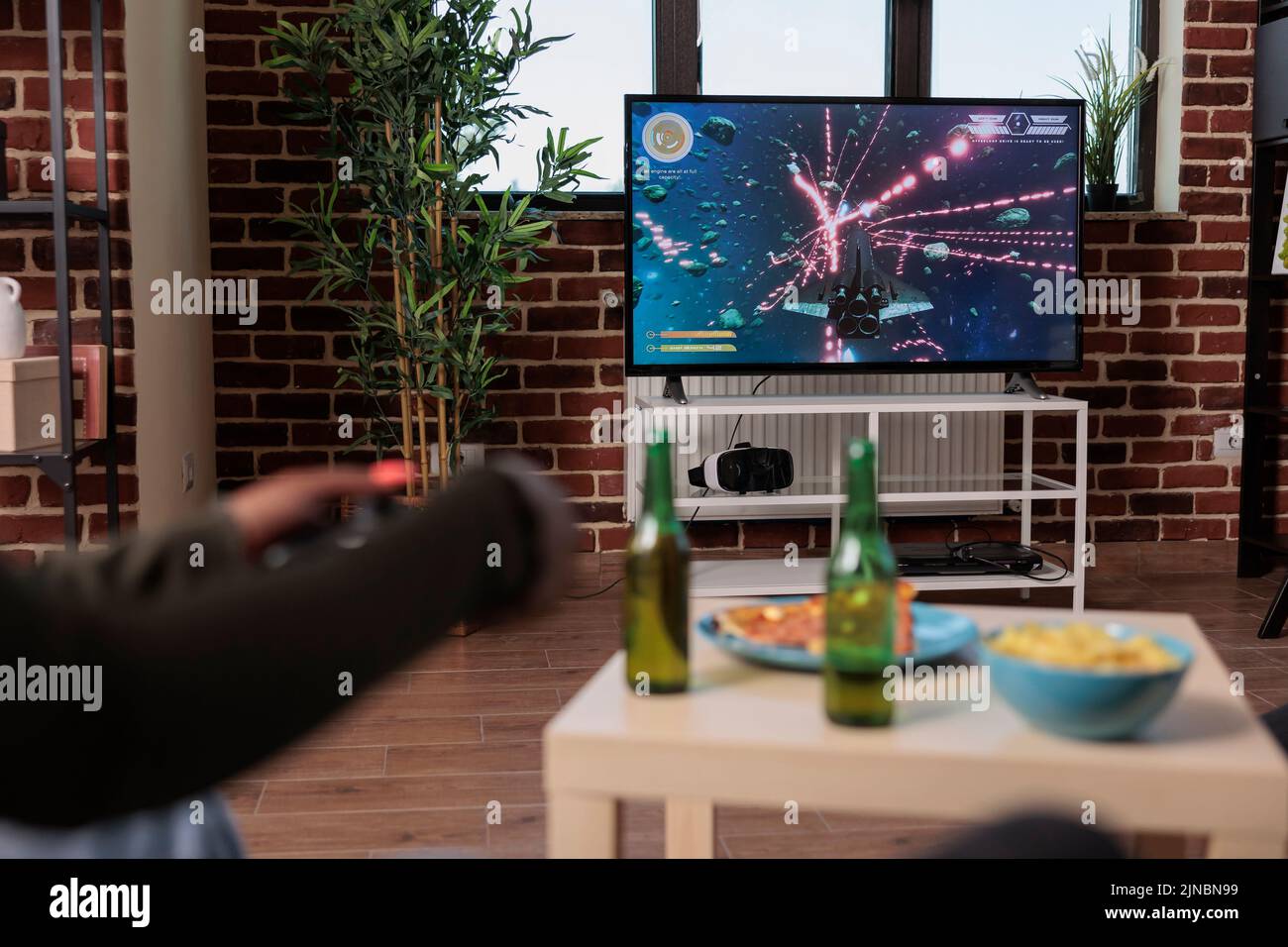 Young woman having fun with shooting video games on console, playing ...