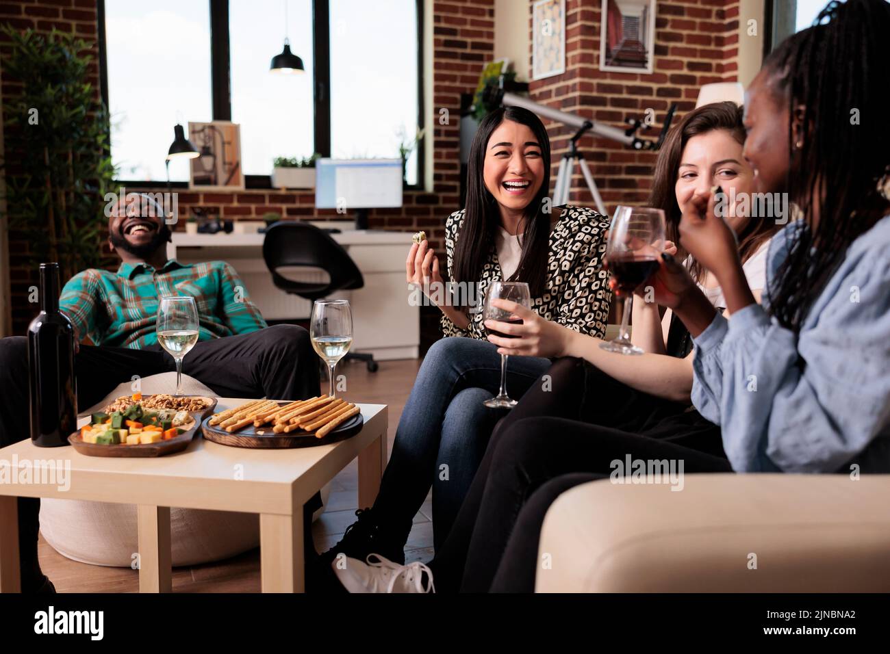 Close friends having wine party and laughing with mouth wide open while ...