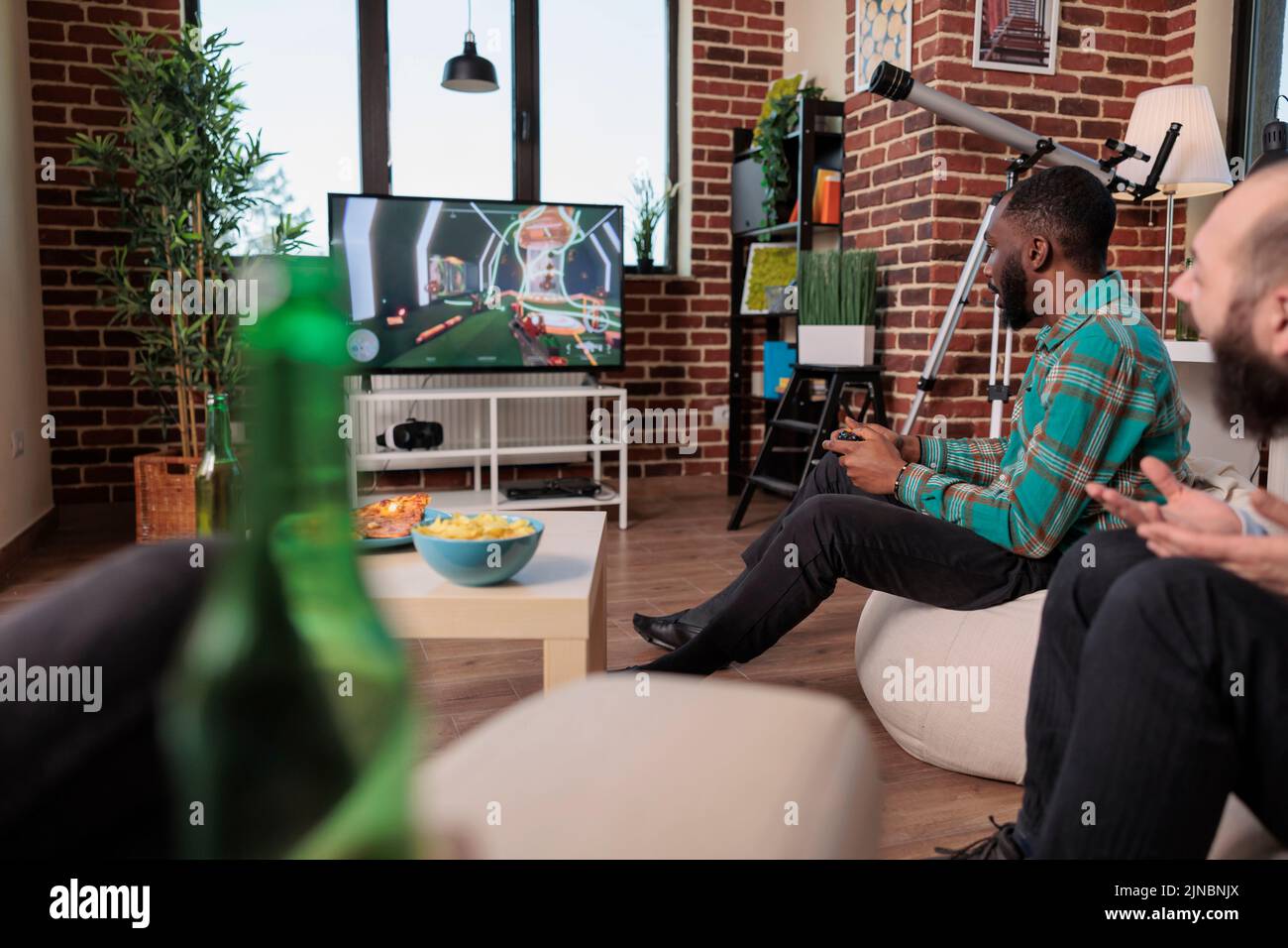Multiethnic group of friends playing shooting video games on tv console ...