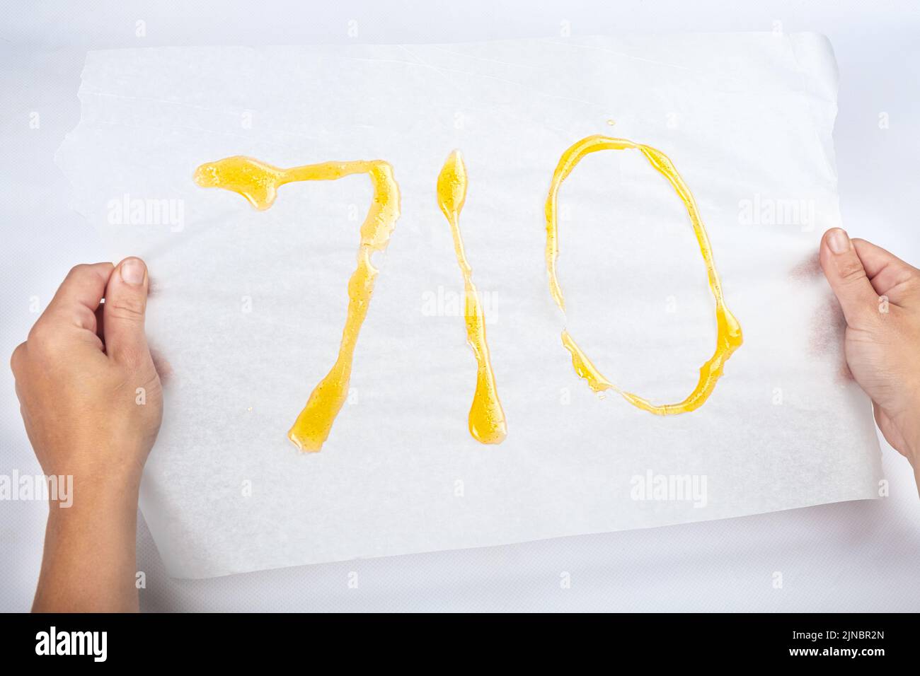 710 cannabis wax day concept, golden dab text in hand Stock Photo - Alamy