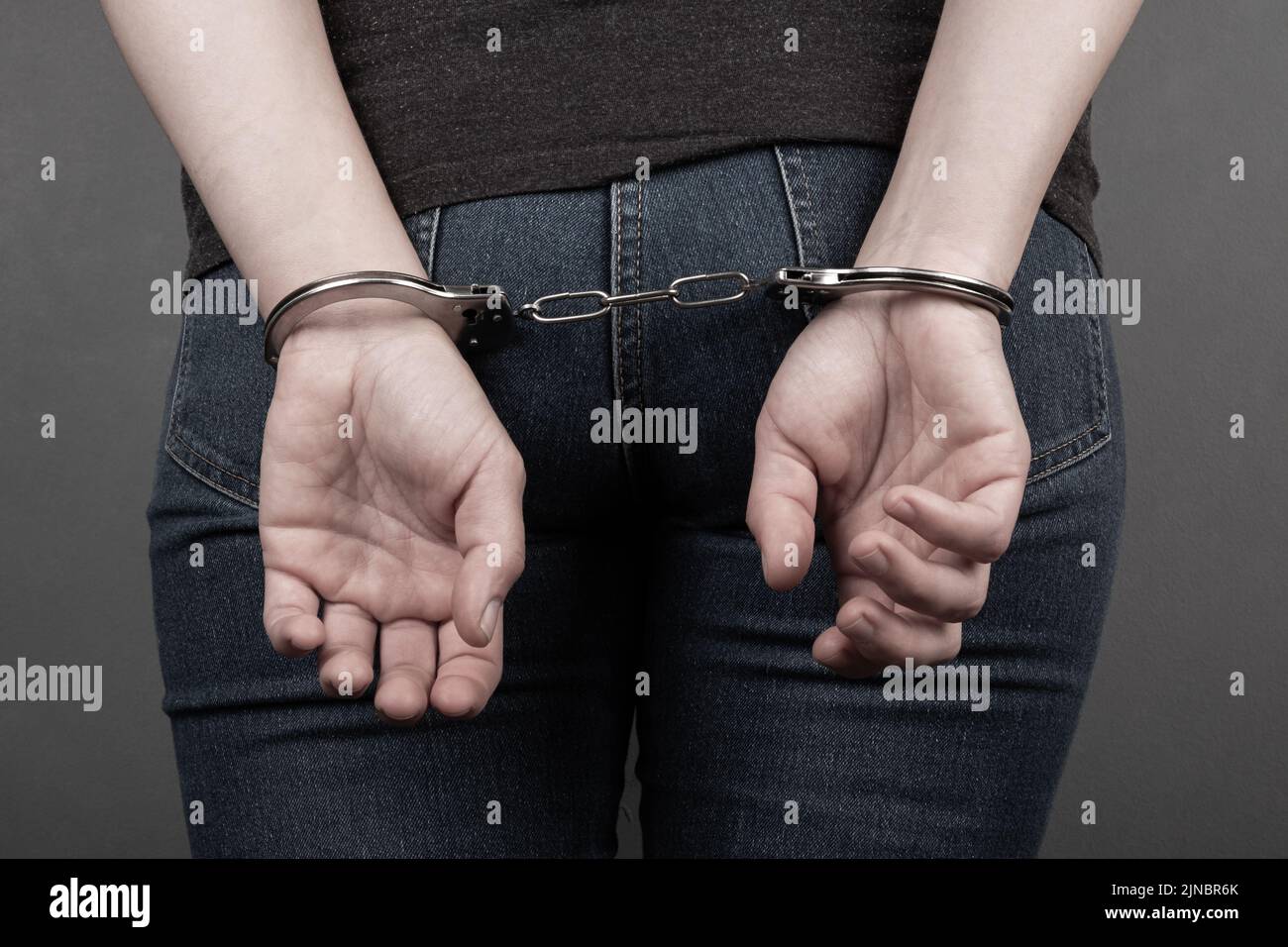 woman chained in handcuffs back view Stock Photo - Alamy