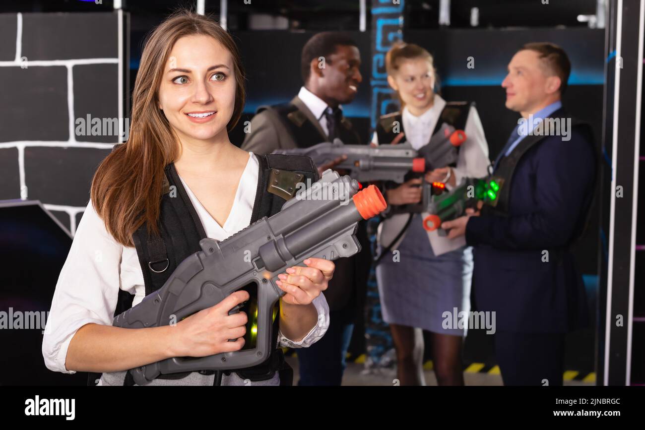 Woman holding laser gun and playing laser tag Stock Photo - Alamy