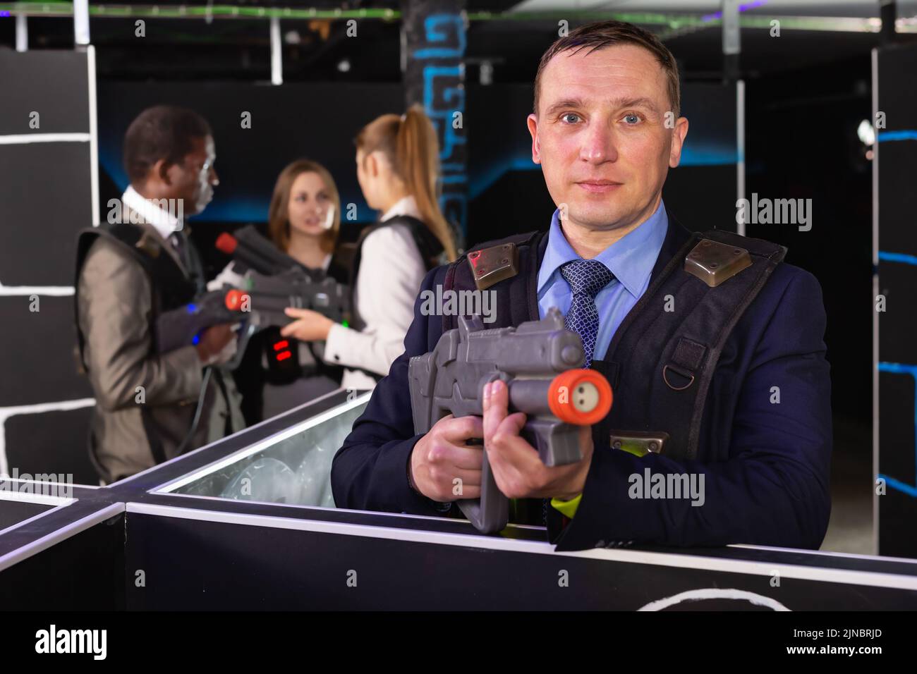 Man holding laser gun and playing laser tag Stock Photo - Alamy