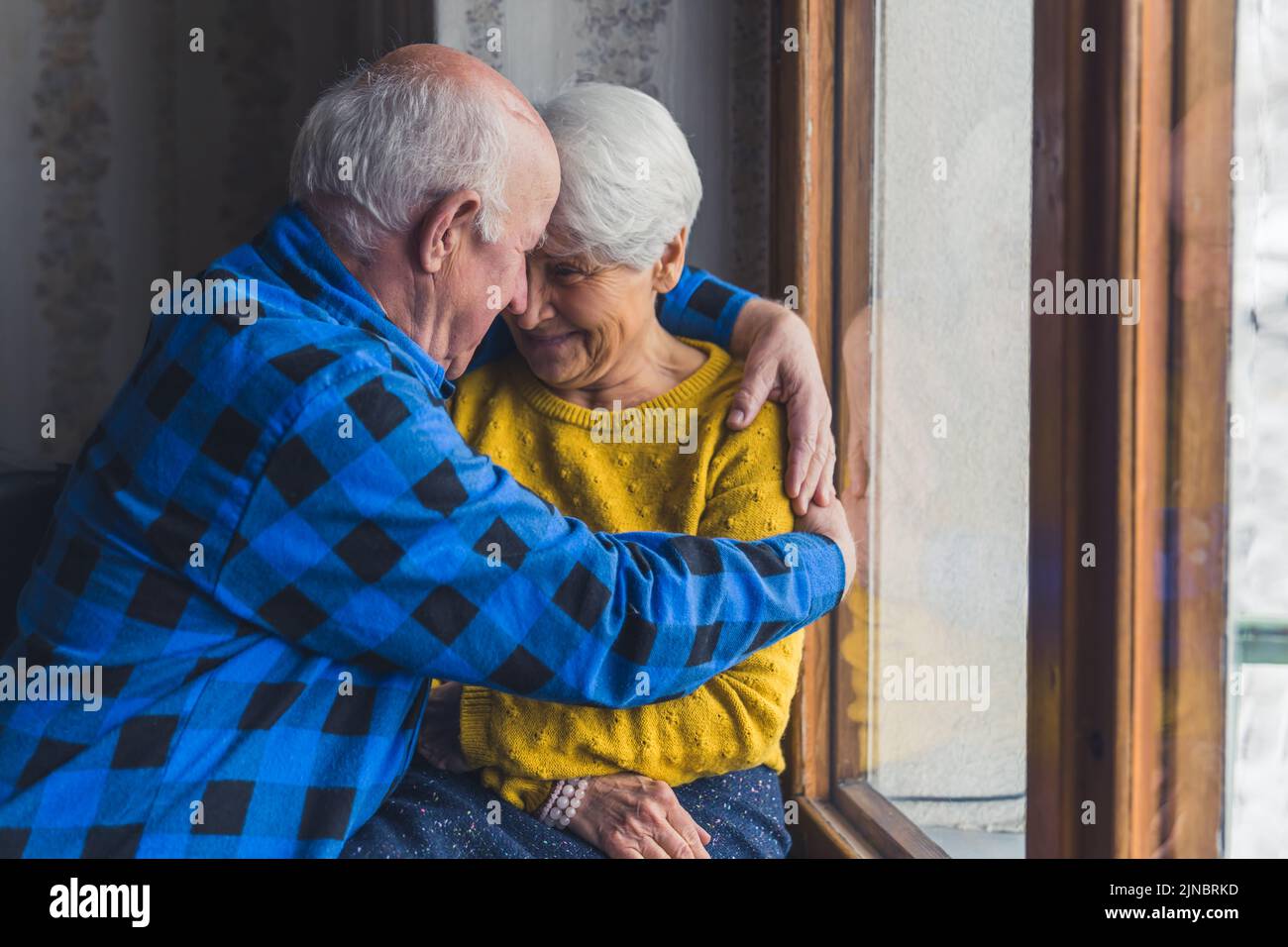 Happy loving senior family couple smiling, hugging, and touching ...