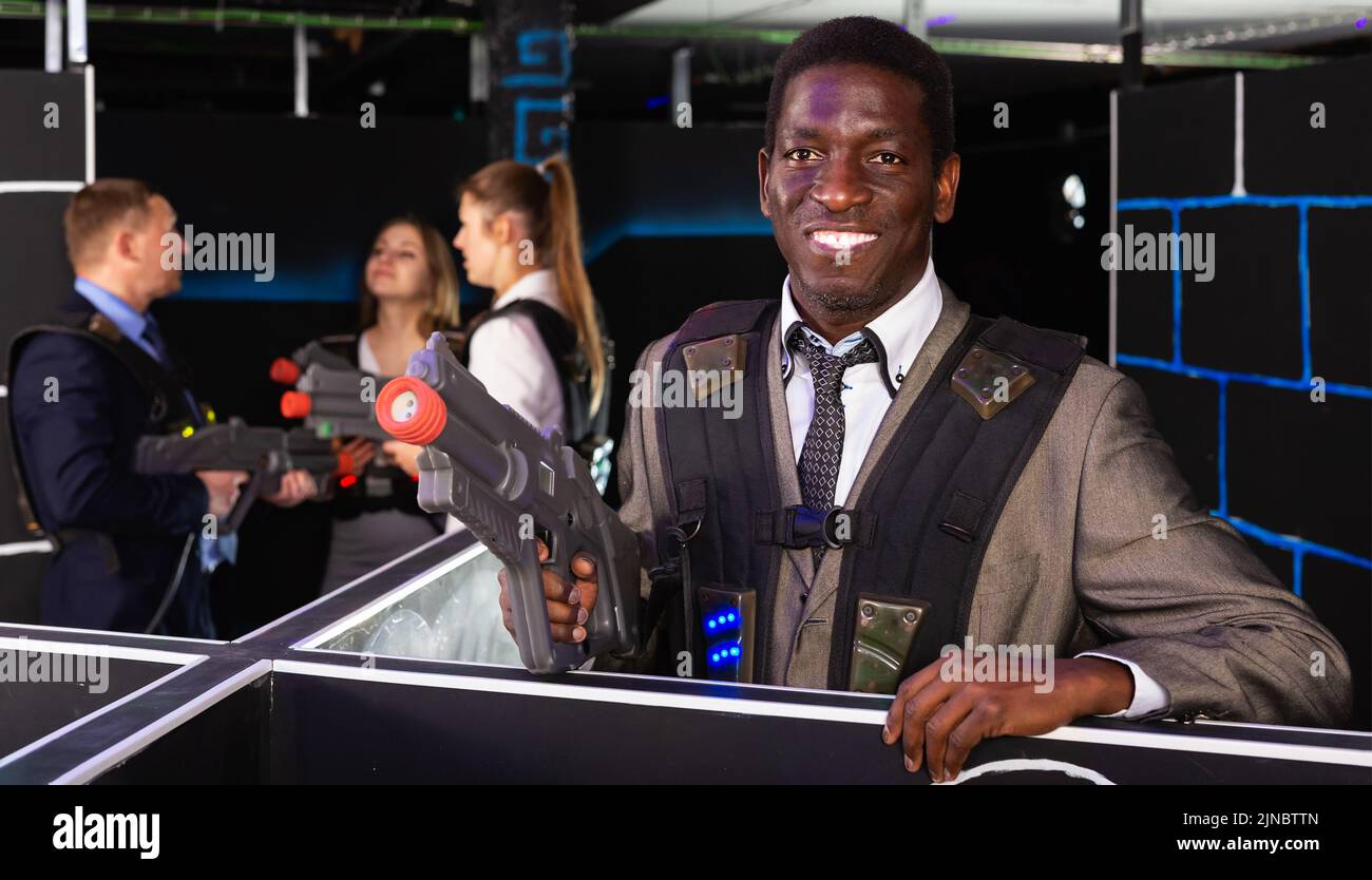 African businessman playing laser tag Stock Photo - Alamy
