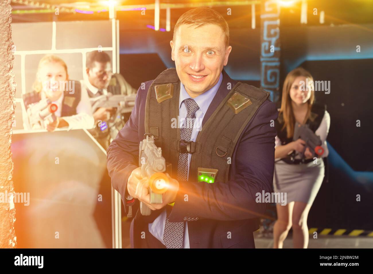 Man holding laser gun and playing laser tag Stock Photo - Alamy
