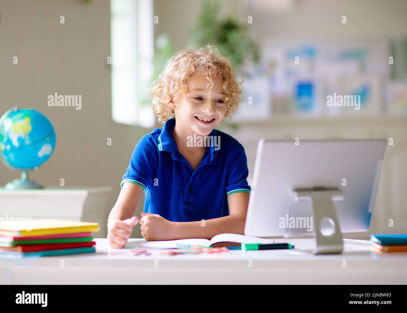 Online remote learning. School kids with computer having video ...