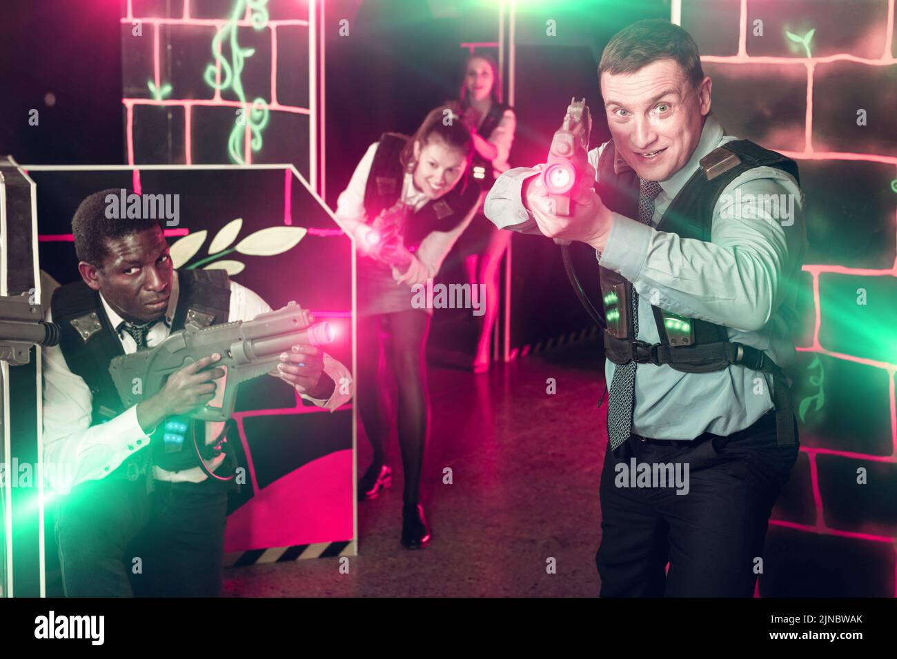 Men and women in business suits playing laser tag emotionally in Stock ...