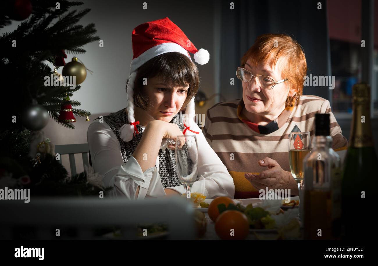 Quarrel of elderly mom and adult daughter on Christmas night Stock ...