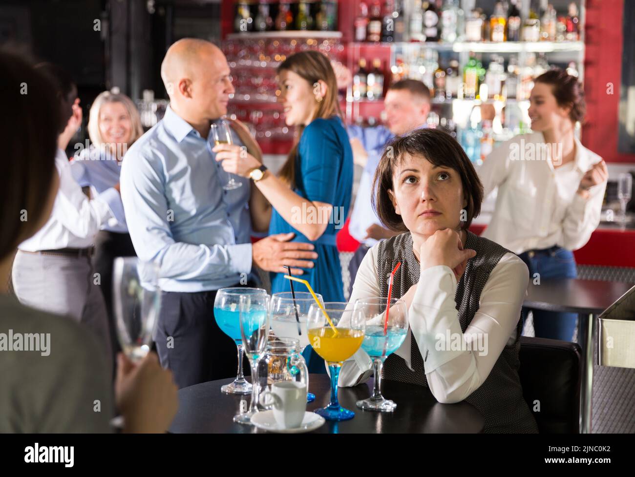 Bored woman at corporate party Stock Photo - Alamy