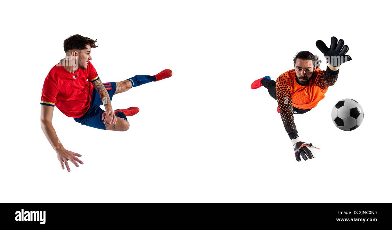 Goalkeeper catches the ball during a football game on white background ...