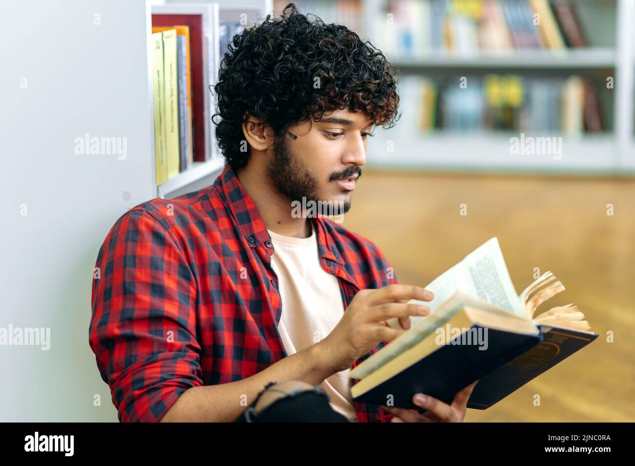 Clever concentrated indian guy doing hi-res stock photography and ...