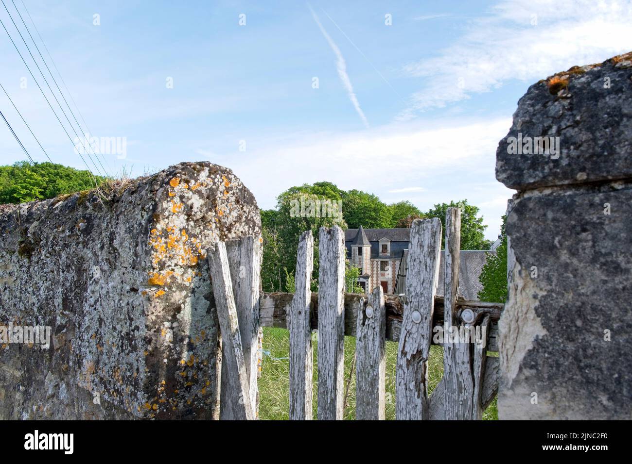Looking through a gate/fence to a beautiful mansion in Loire Valley ...